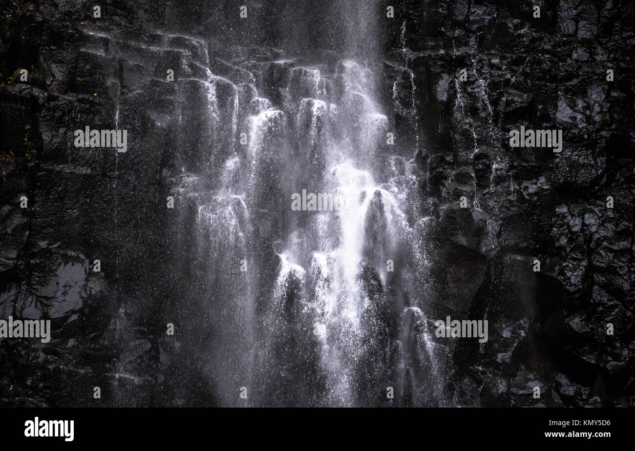 A fierce waterfall striking black volcanic rock Stock Photo - Alamy