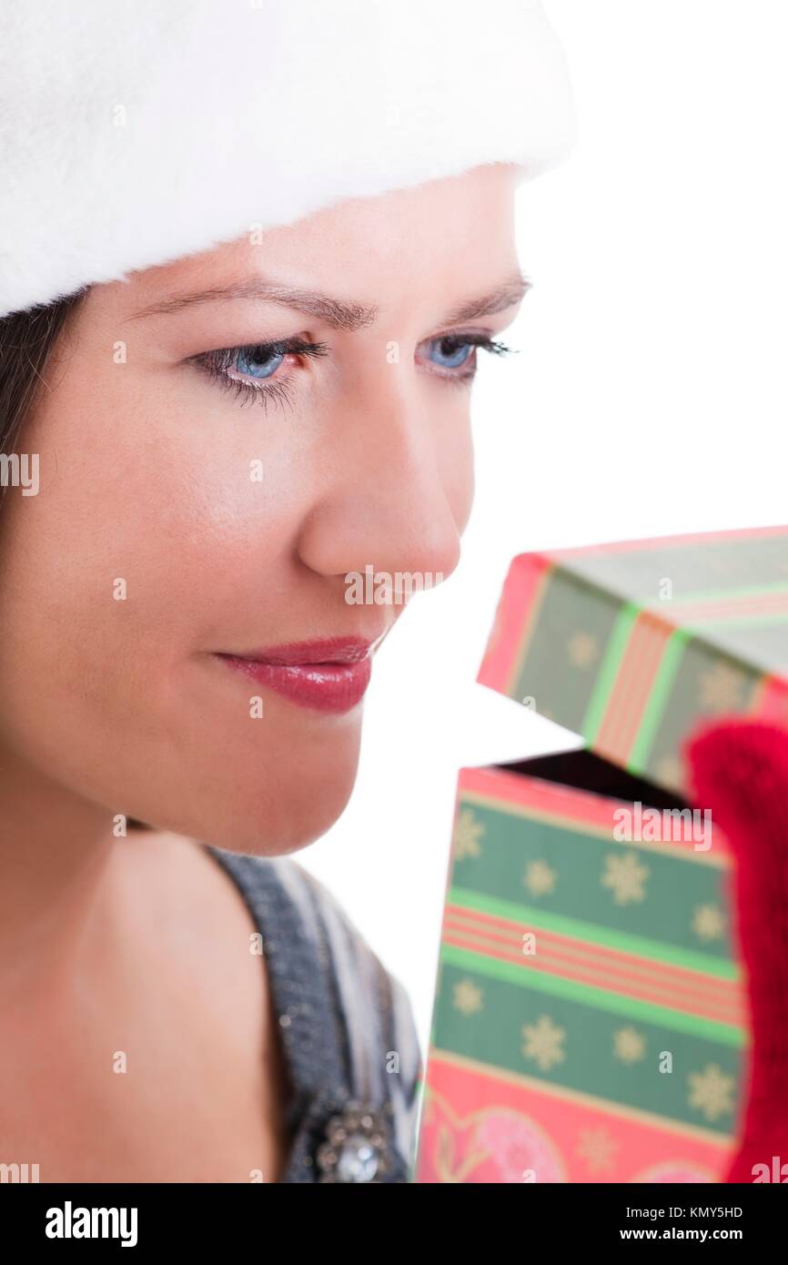 Happy young woman opening a Christmas present Stock Photo - Alamy