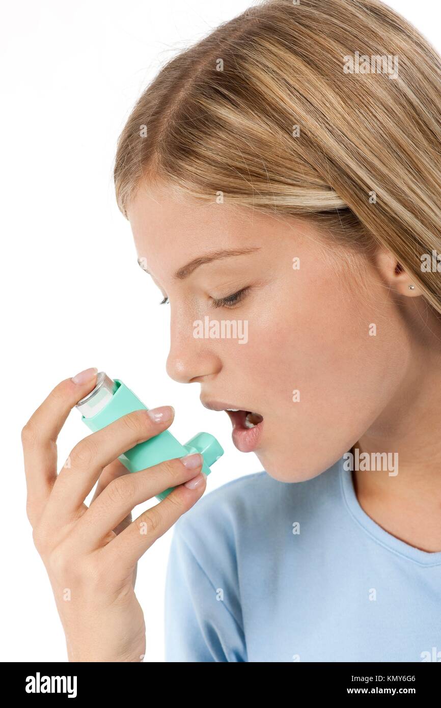 Young woman using asthma inhaler Stock Photo - Alamy