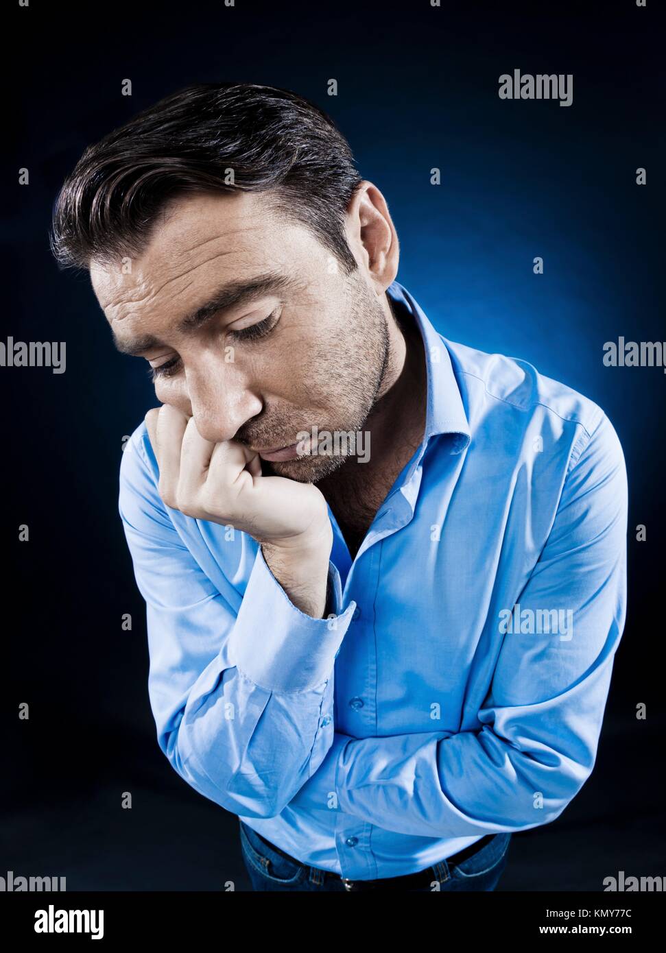 caucasian man unshaven portrait sulk tired isolated studio on black ...