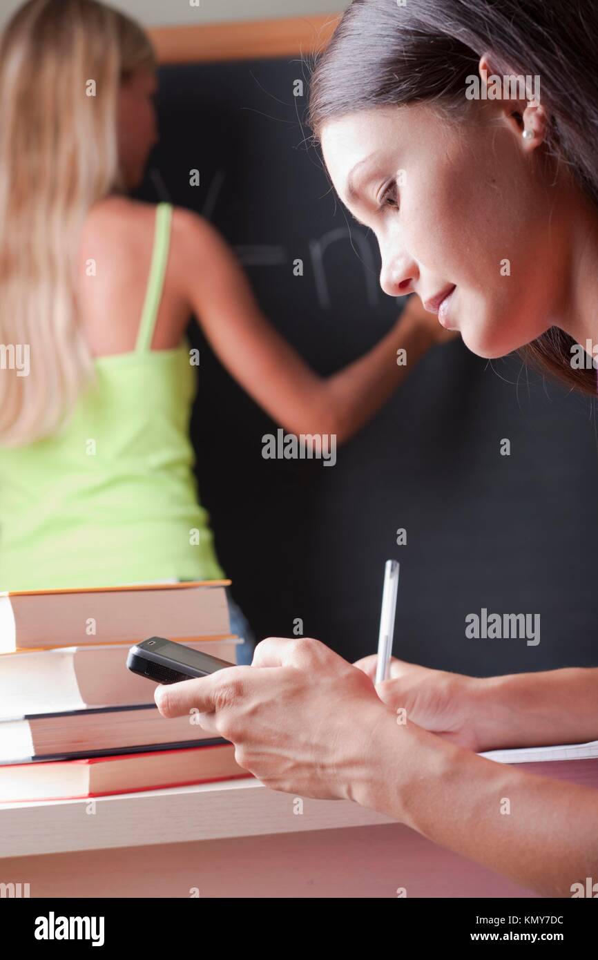 Checking mobile phone while at school Stock Photo - Alamy