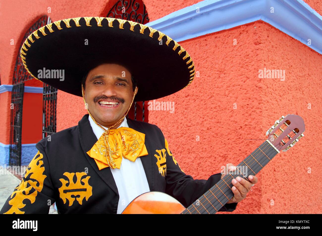 Charro Mariachi singer playing guitar in Mexico houses background Stock ...