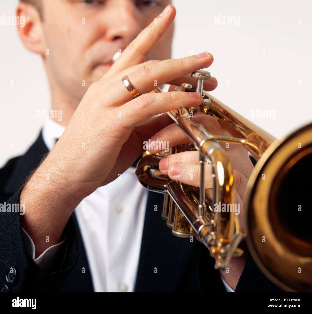 Closeup of the hands of an European musician playing the trumpet Stock ...