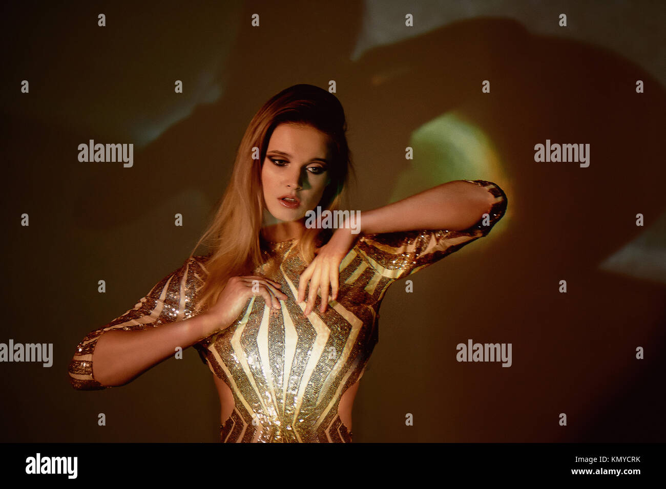 Abstract portrait of a beautiful girl in the light of the projector ...