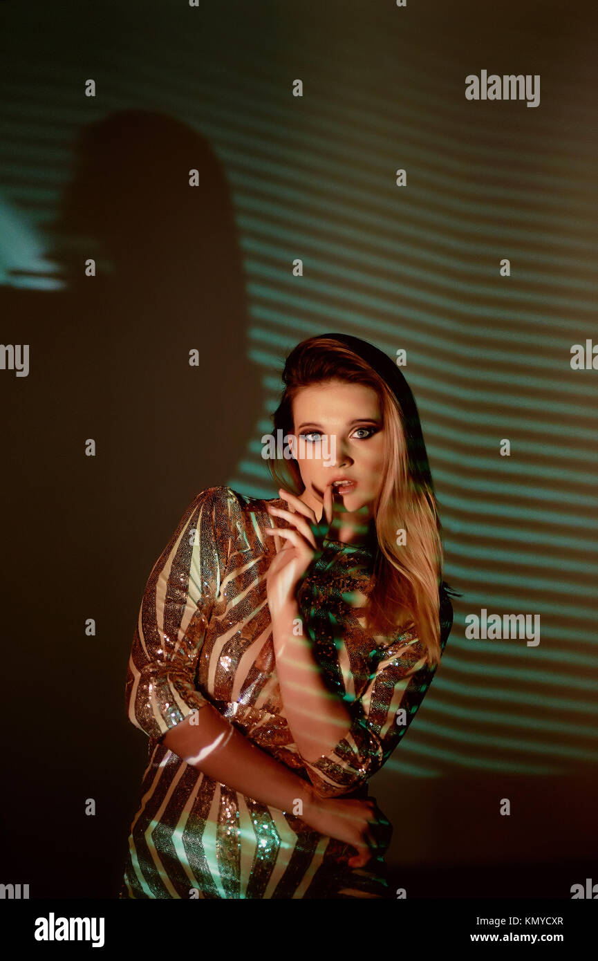 Abstract portrait of a beautiful girl in the light of the projector ...