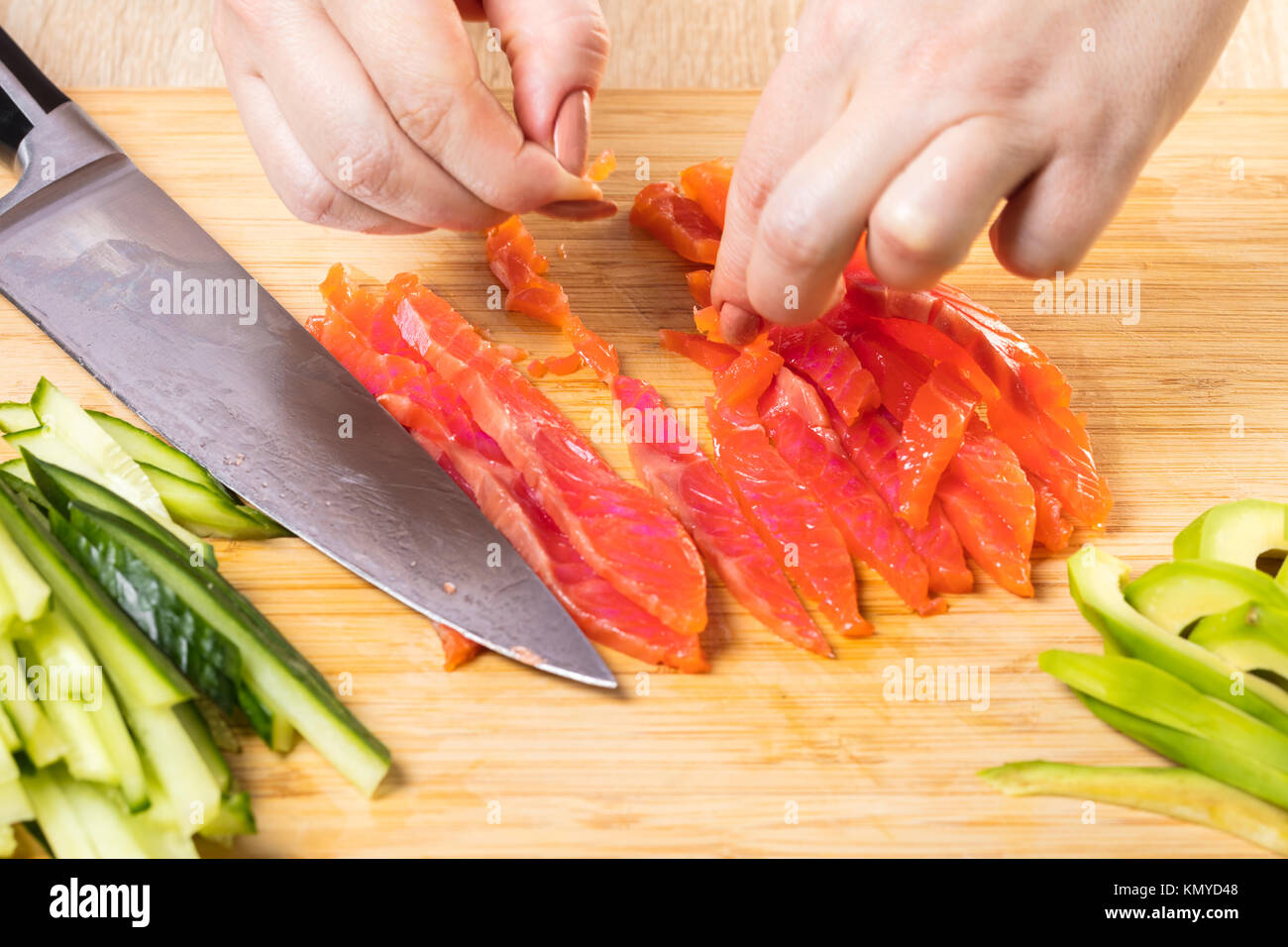 the chef cuts red fish, hands close-up Stock Photo - Alamy