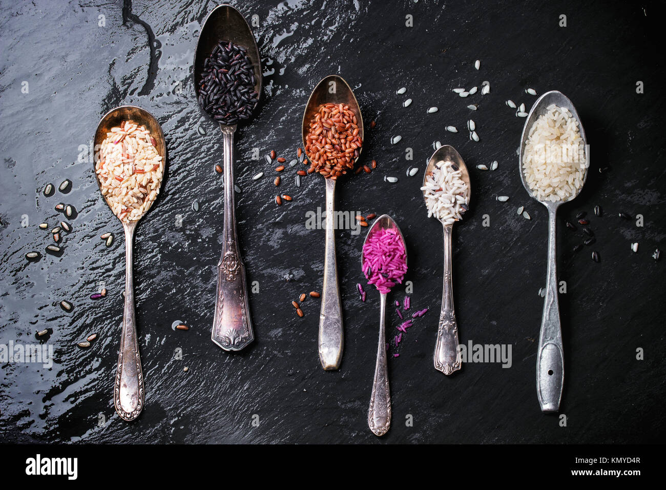 Set of unusual rice in vintage spoons over dark surface. Top view Stock ...