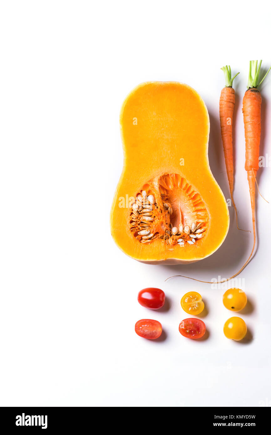 Set of whole and sliced red, orange and yellow vegetables over white ...