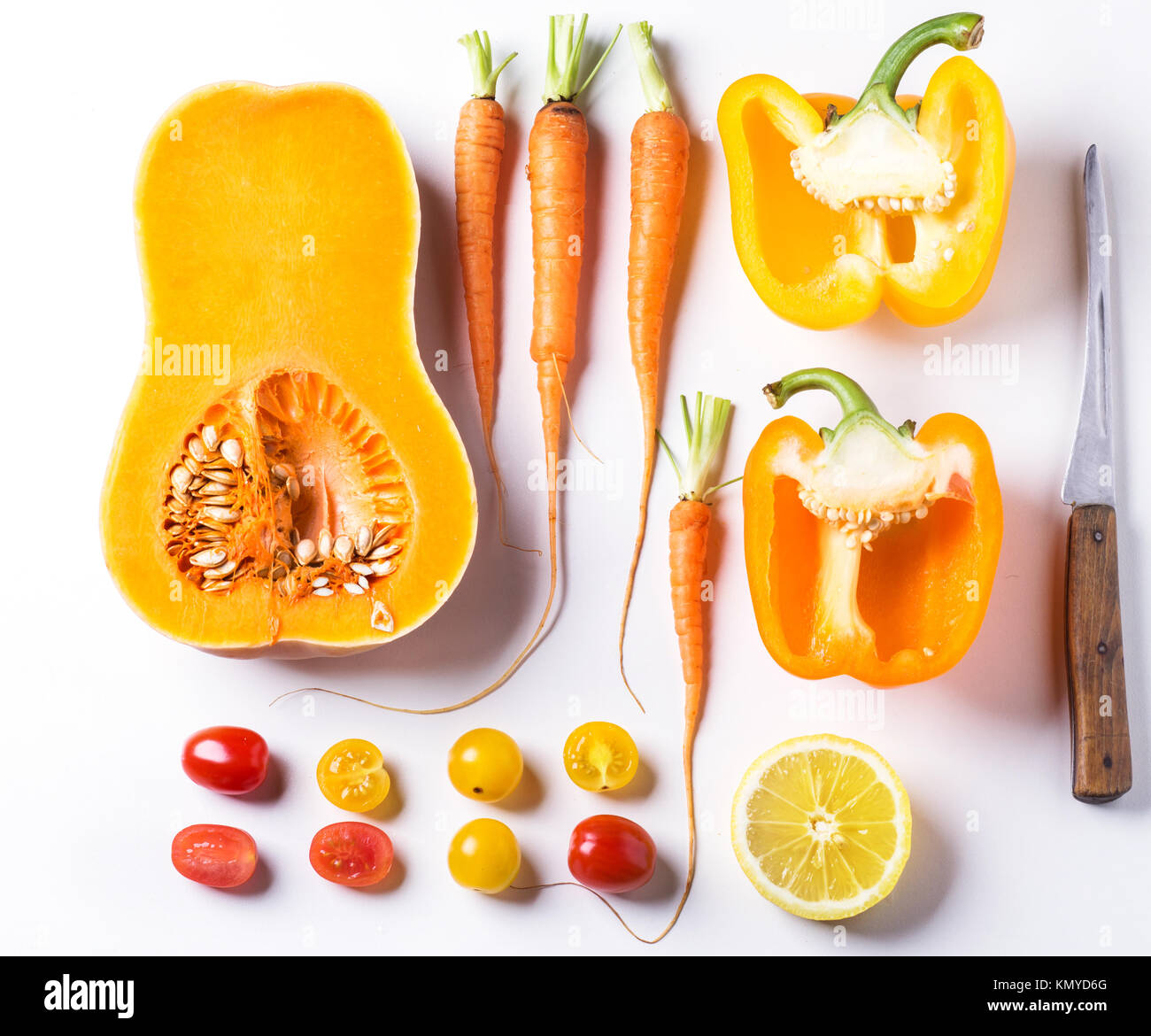 Set of whole and sliced red, orange and yellow vegetables over white ...