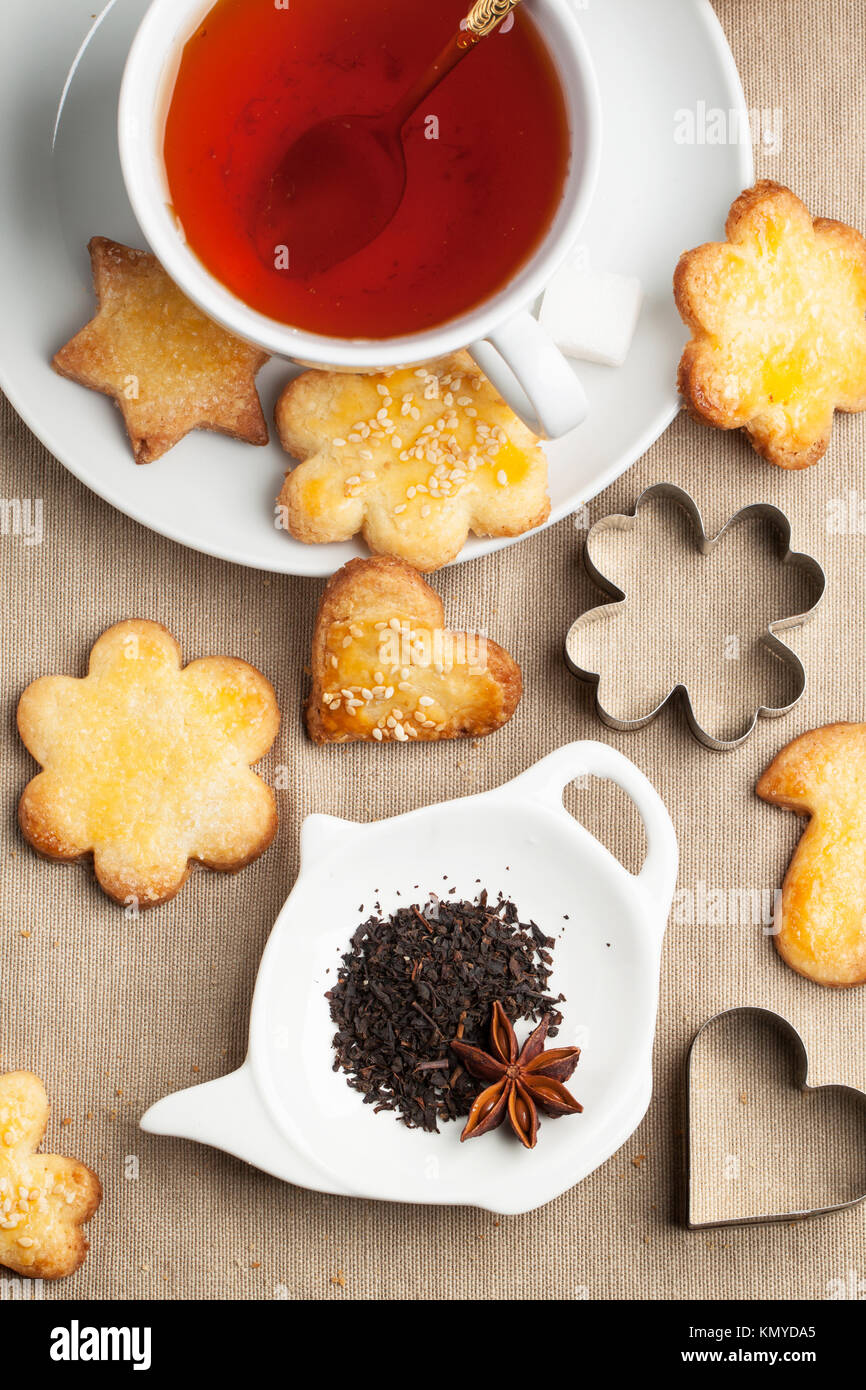 Top view on cup of black tea served with homemade sugar cookies, dry ...