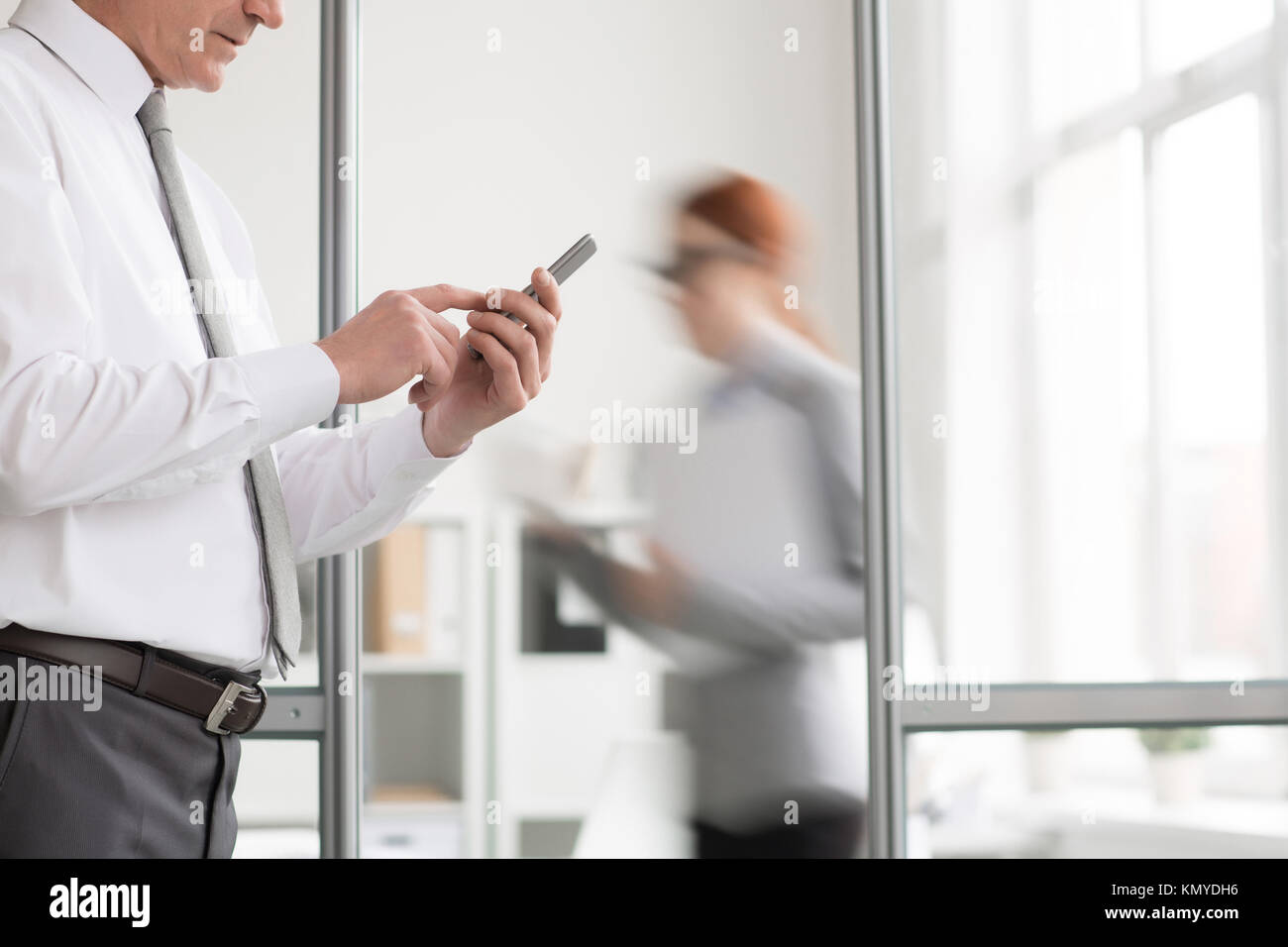 Texting in office Stock Photo - Alamy