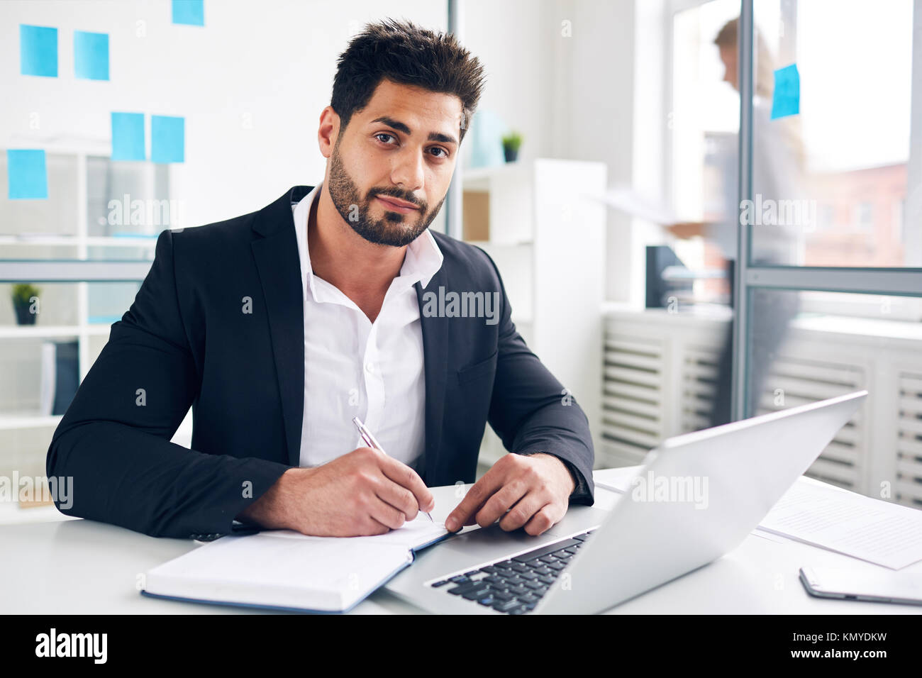 Young businessman writing down meeting hi-res stock photography and ...