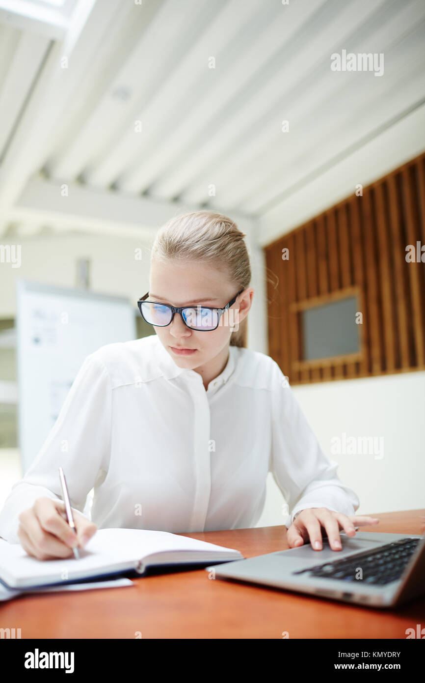 Girl making notes Stock Photo - Alamy
