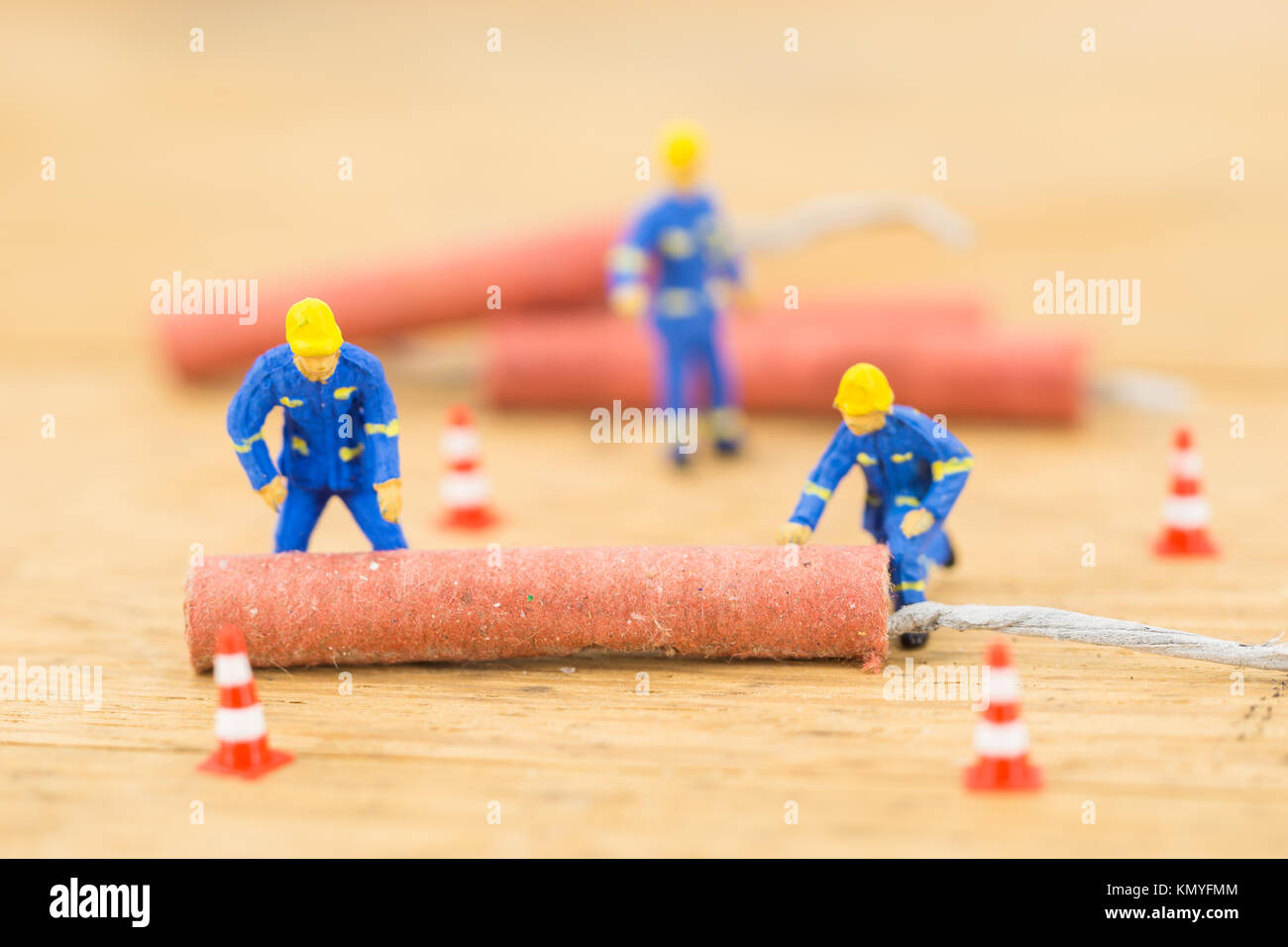 Concept miniature people working hard on Firecracker Stock Photo - Alamy