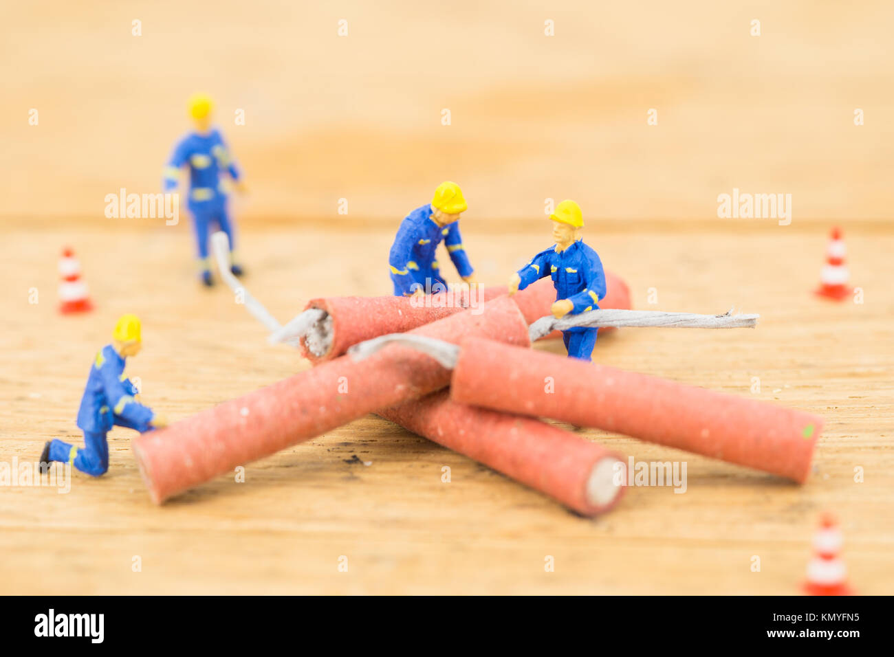 Concept miniature people working hard on Firecracker Stock Photo - Alamy
