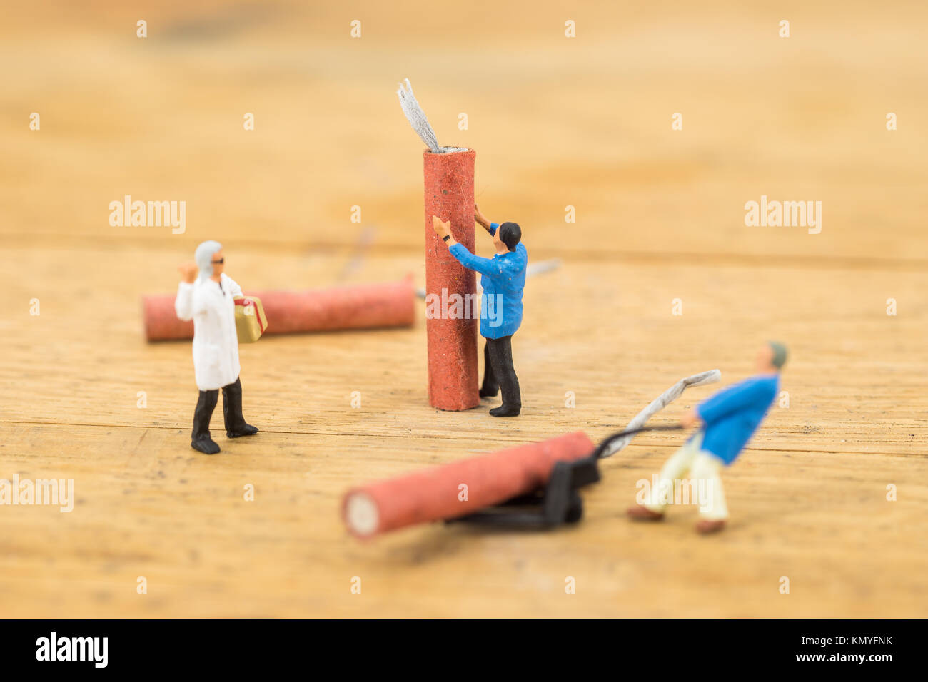 Concept miniature people working hard on Firecracker Stock Photo - Alamy