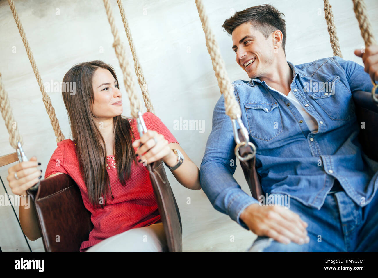 Young couple relaxing in swing Stock Photo - Alamy