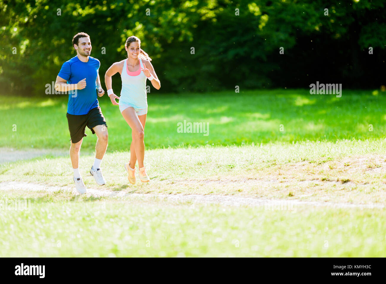 Young people running in nature Stock Photo - Alamy