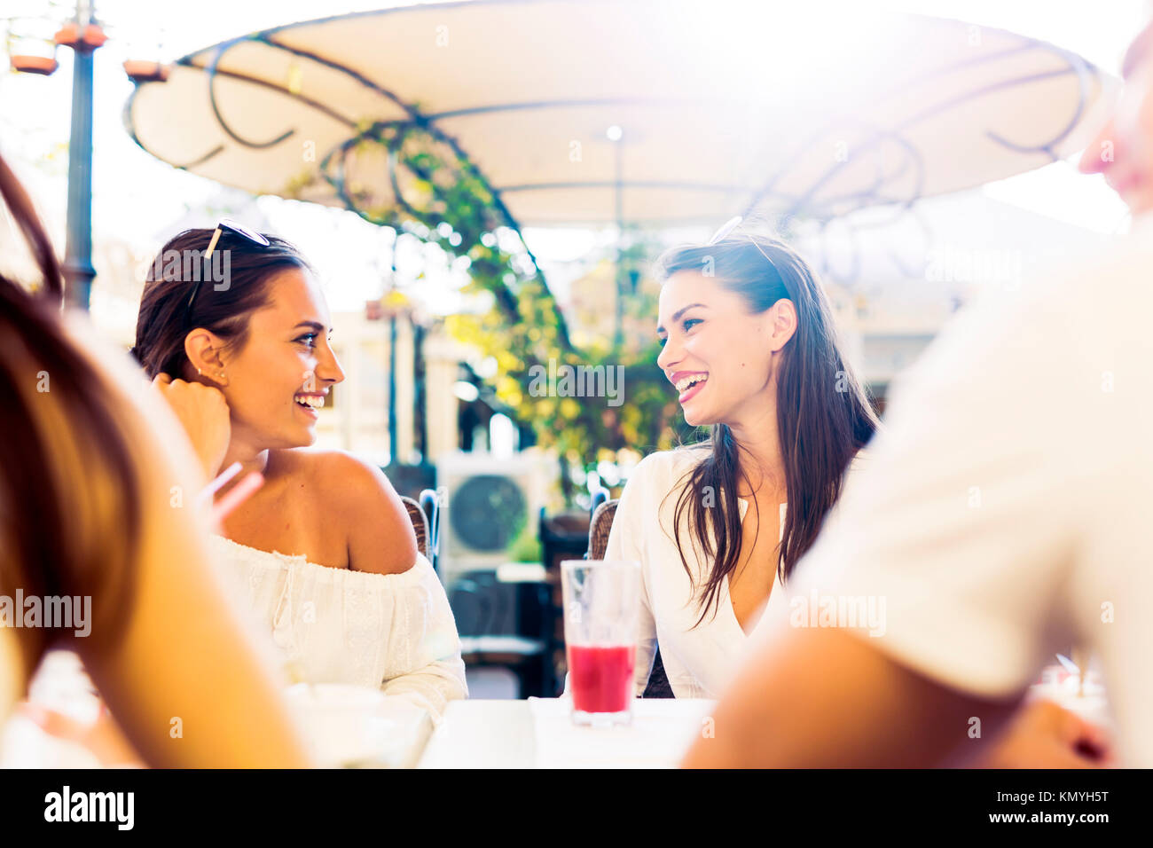 Two young girls talking during lunch break Stock Photo - Alamy