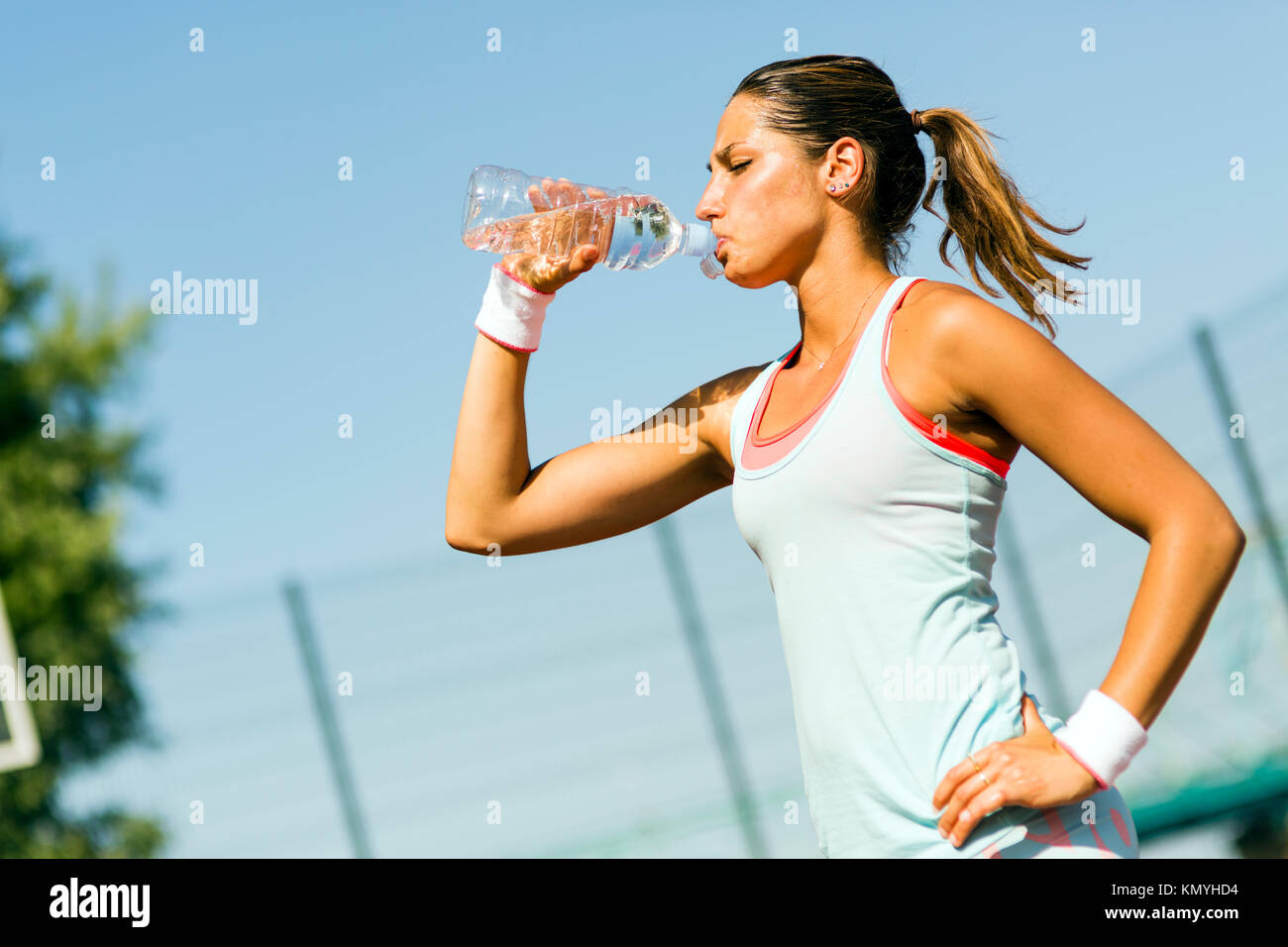 Young beautiful athlete drinking water after exercising Stock Photo - Alamy