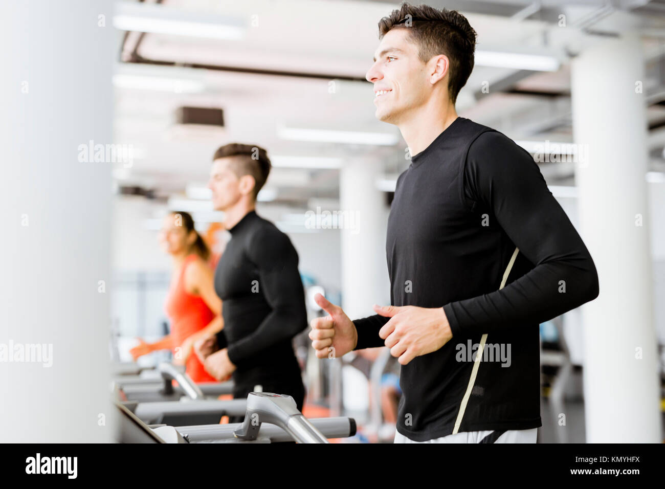 Group of young people using treadmills in a gym Stock Photo - Alamy