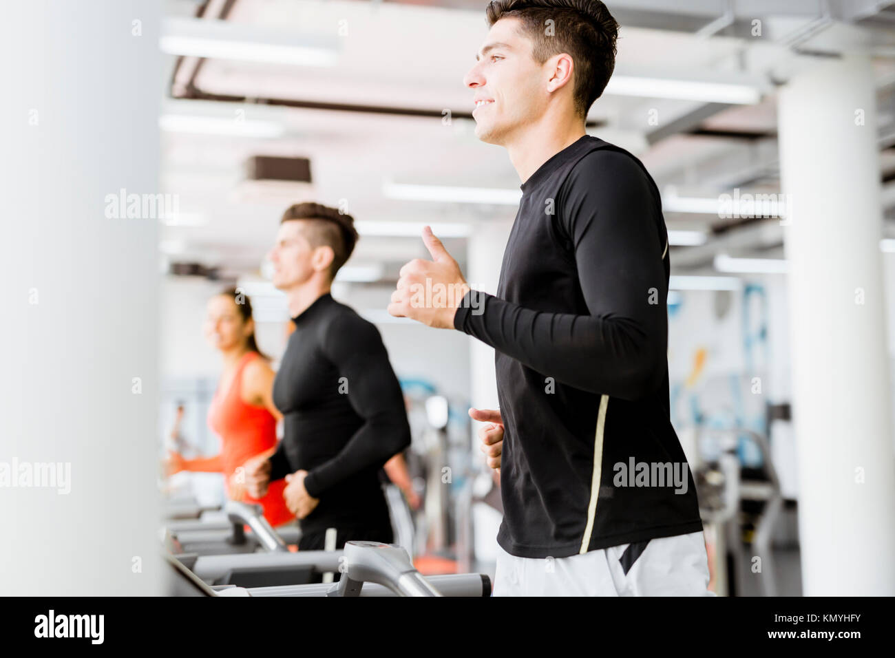 Group of young people using treadmills in a gym Stock Photo - Alamy
