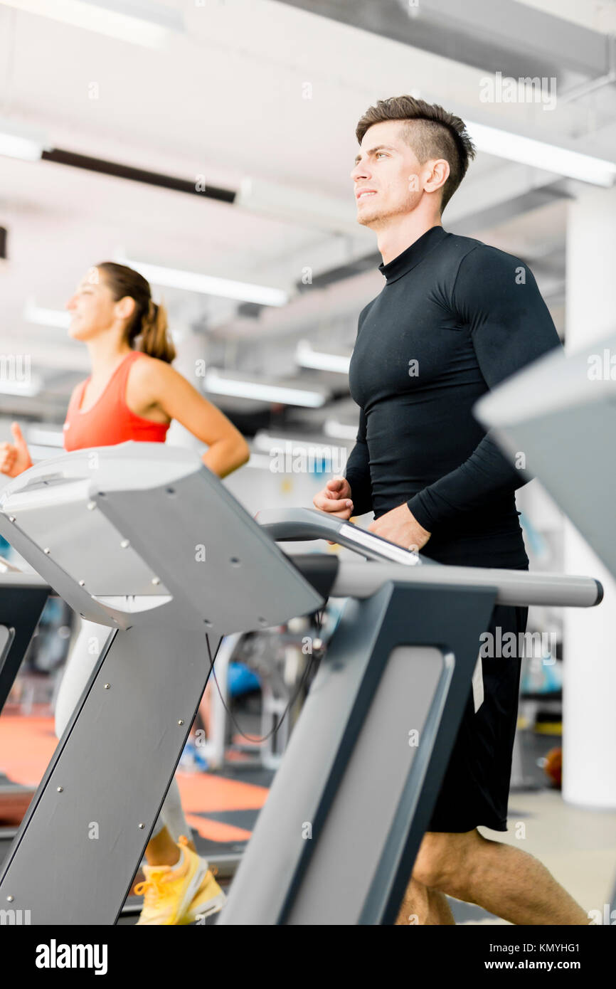 Group of young people using treadmills in a gym Stock Photo - Alamy