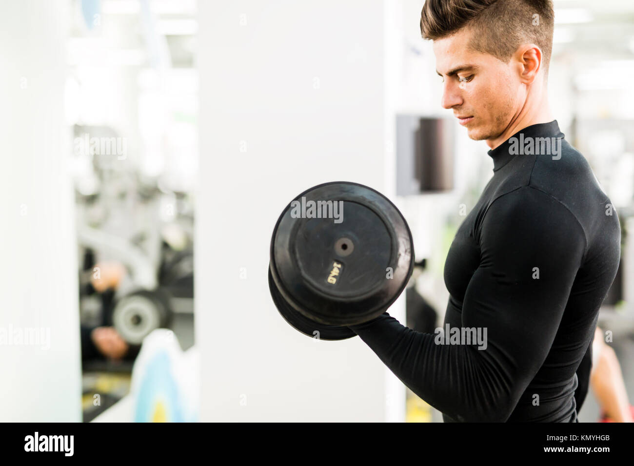 Young handsome man working out in a gym Stock Photo - Alamy
