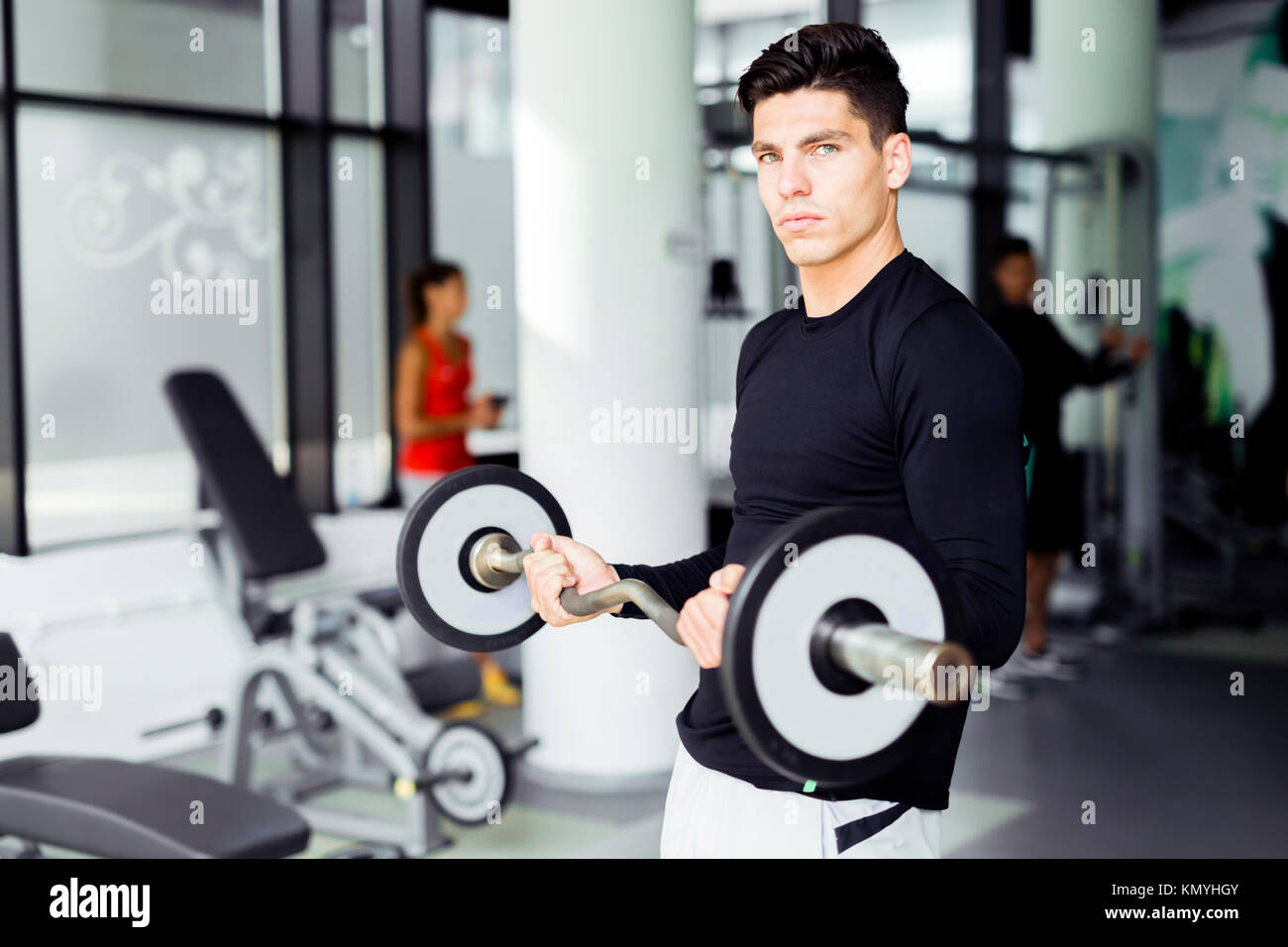 Young man training in a gym Stock Photo - Alamy