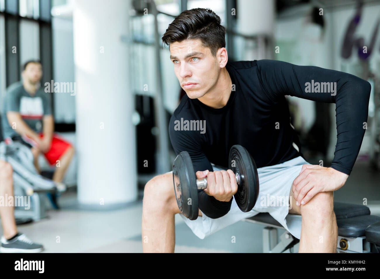 Young man training in a gym Stock Photo - Alamy
