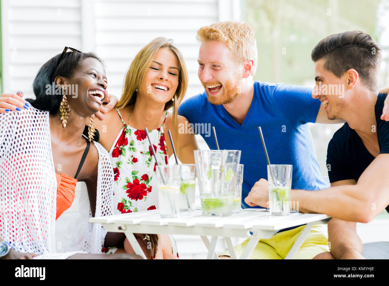 Happy young people laughing a being happy at a table Stock Photo - Alamy