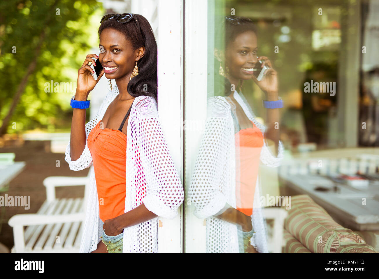 Beautiful black woman talking on phone and smiling Stock Photo - Alamy