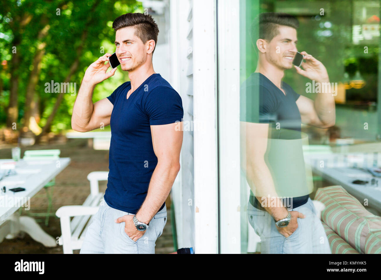 Handsome man talking on the phone outdoors Stock Photo - Alamy