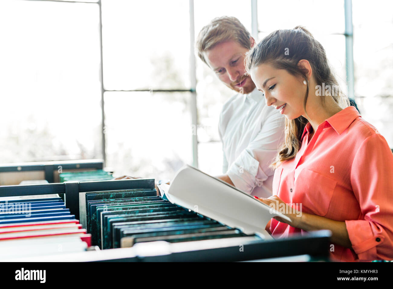 Two students reading and studying in library Stock Photo - Alamy