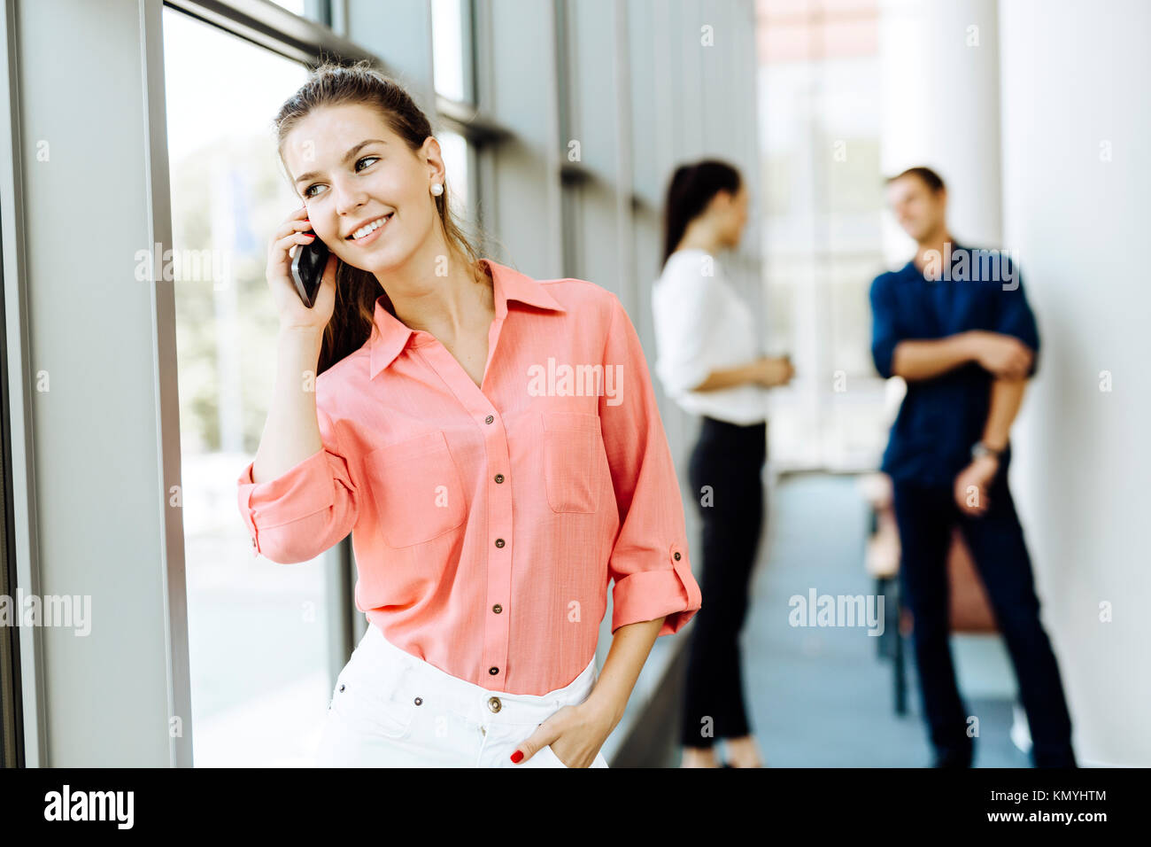 Beautiful women using phones and talkin during break Stock Photo - Alamy