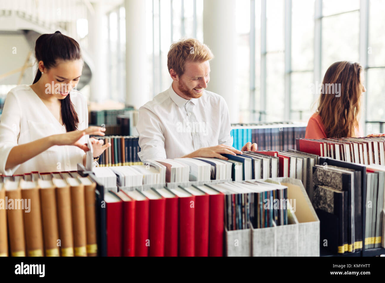 Group of students studying in library Stock Photo - Alamy