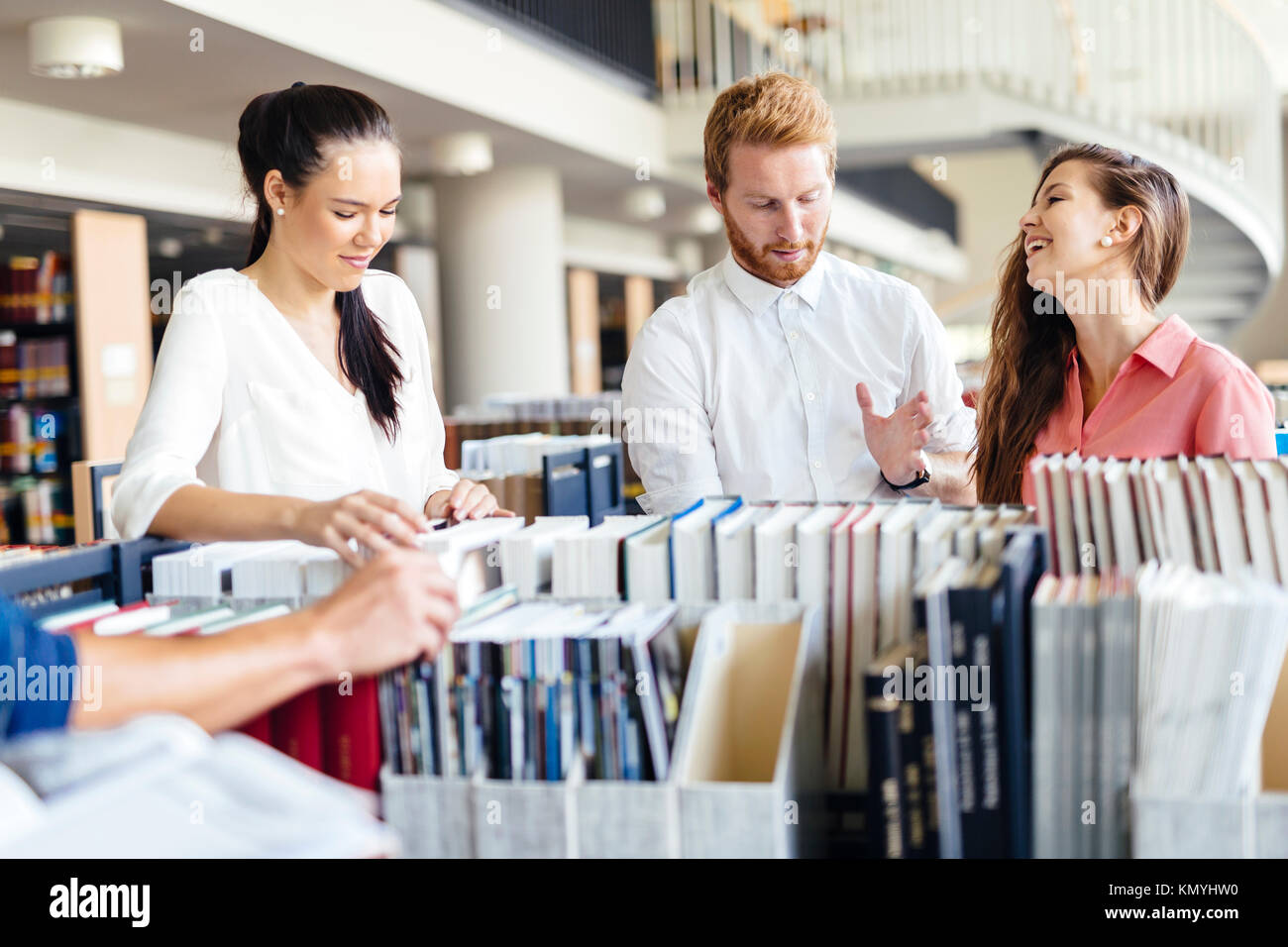 Group of students studying in library Stock Photo - Alamy
