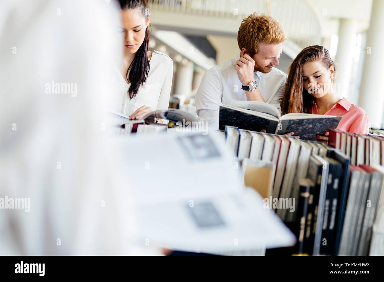 Group of students studying in library Stock Photo - Alamy