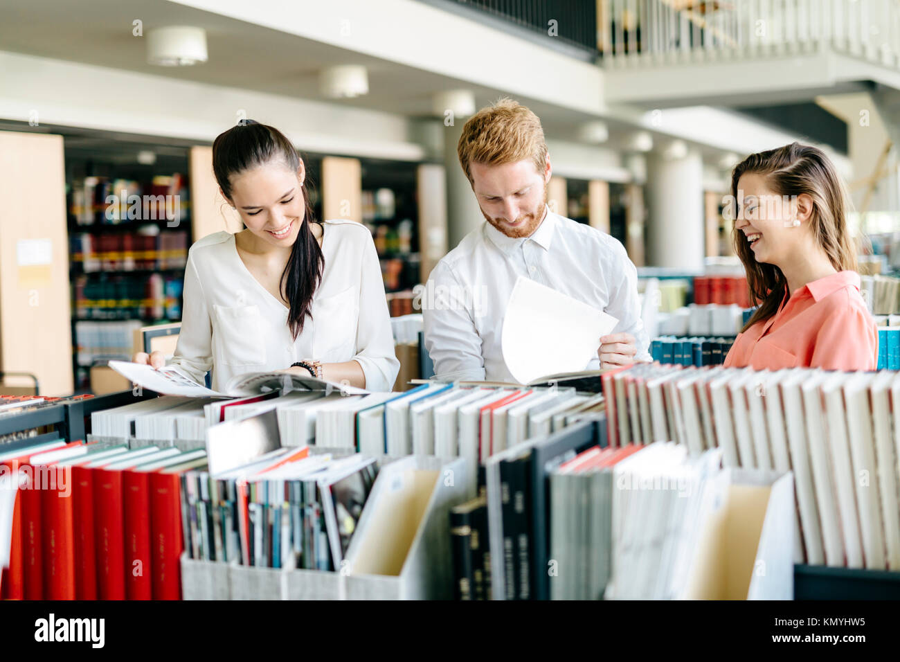 Group of students studying in library Stock Photo - Alamy