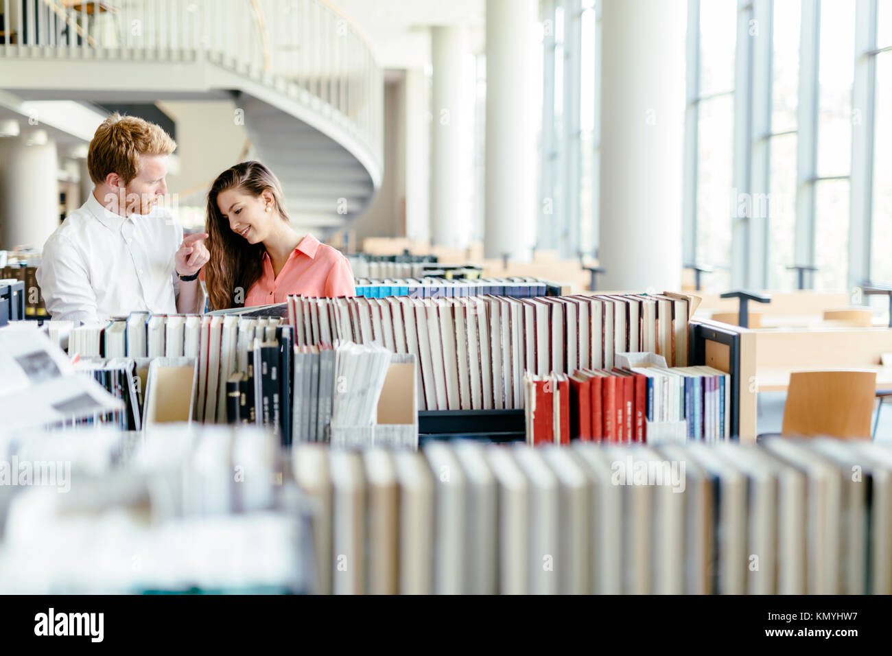 Two students reading and studying in library Stock Photo - Alamy