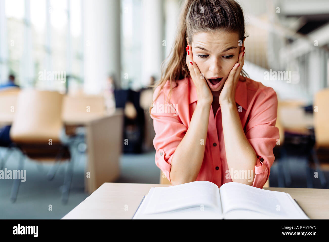 Female student studying in library Stock Photo - Alamy