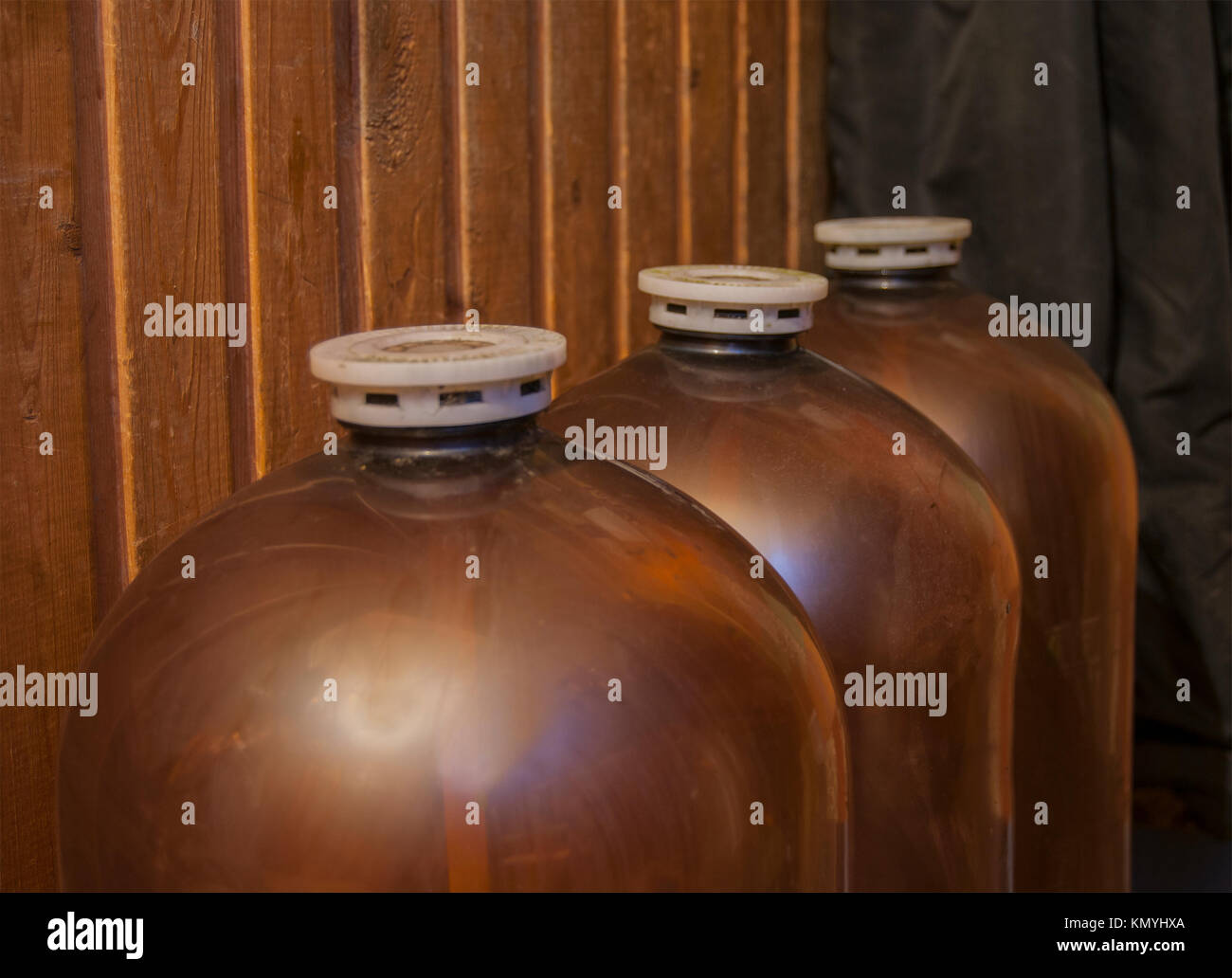 Large plastic kegs for beer, empty stand in a row near the wooden wall ...