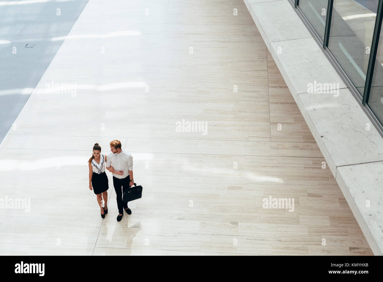 Business couple walking together Stock Photo - Alamy