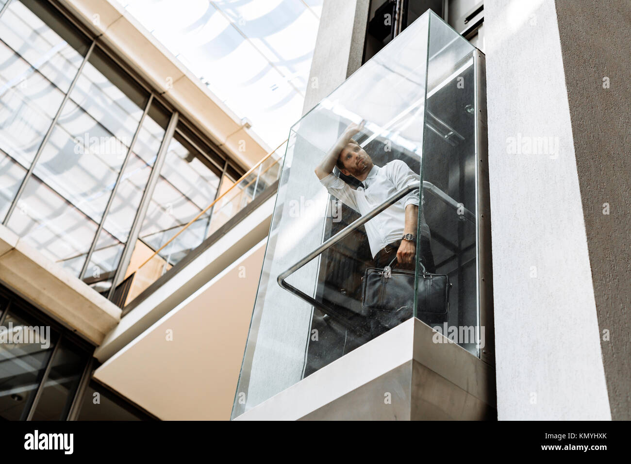 Businessman taking the elevator Stock Photo - Alamy
