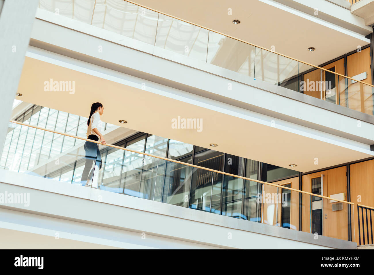 Elegant businesswoman walking inside building Stock Photo - Alamy