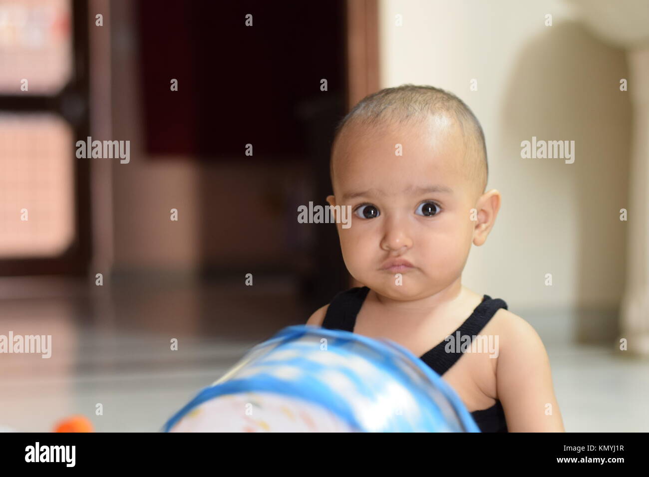 cute little baby looking into camera Stock Photo - Alamy