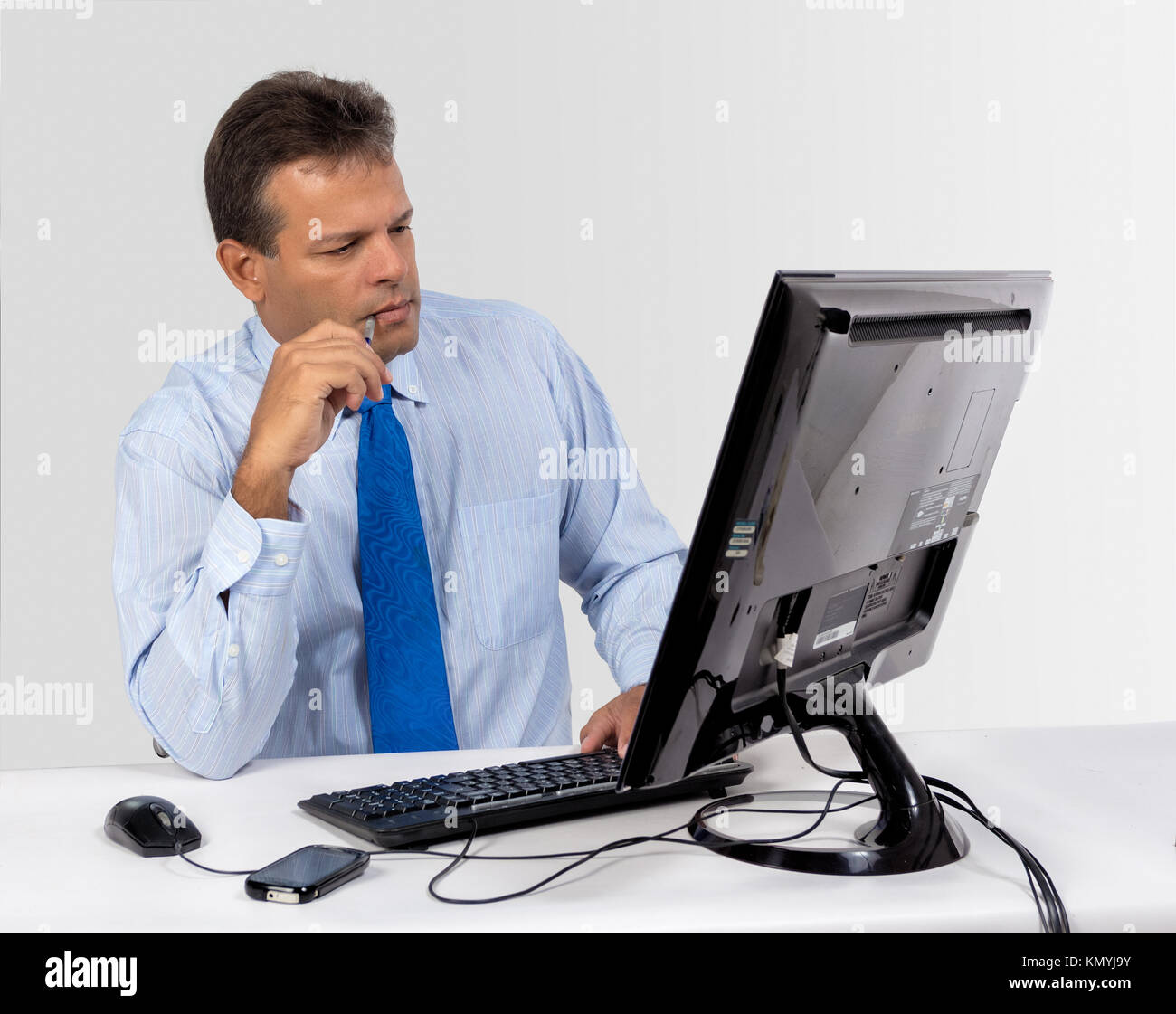 A man wearing blue shirt with a computer Stock Photo - Alamy
