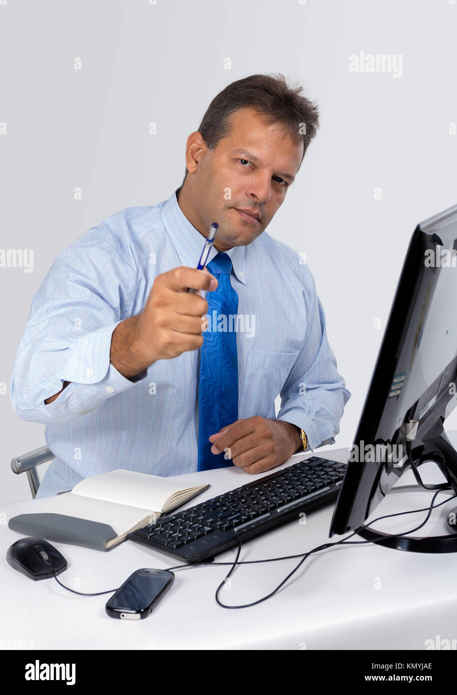 A man wearing blue shirt with a computer Stock Photo - Alamy