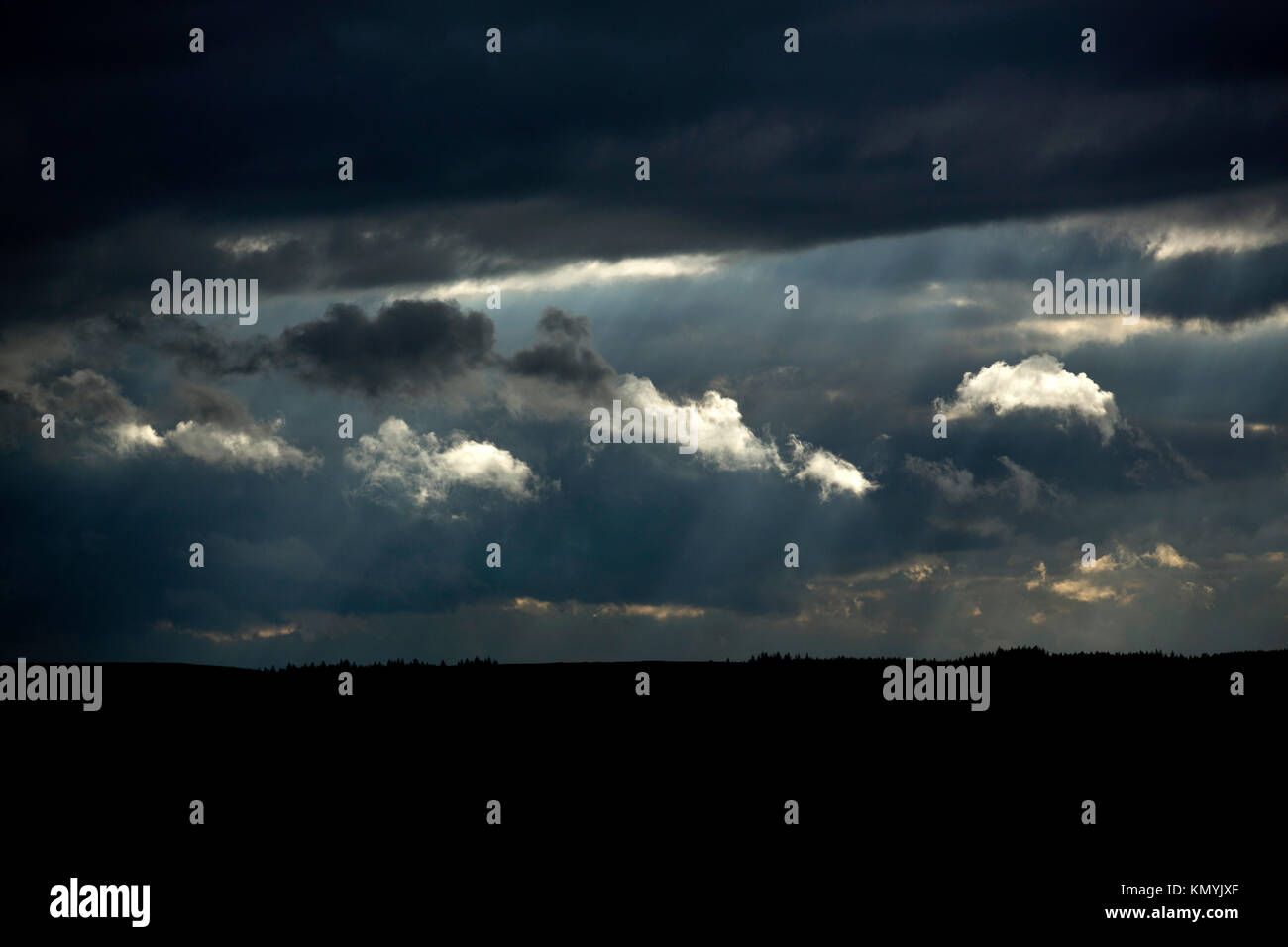 Dramatic Cloudy Sunset Sky with light rays coming through the clouds ...
