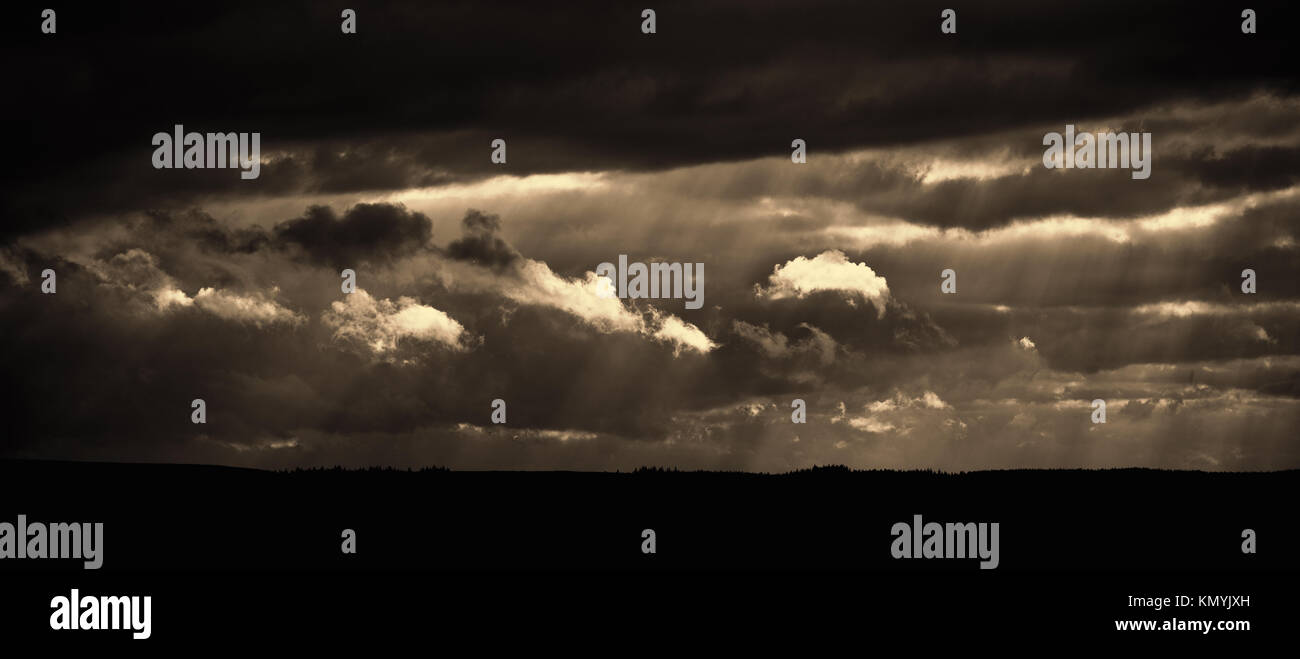 Dramatic Cloudy Sunset Sky with light rays coming through the clouds ...